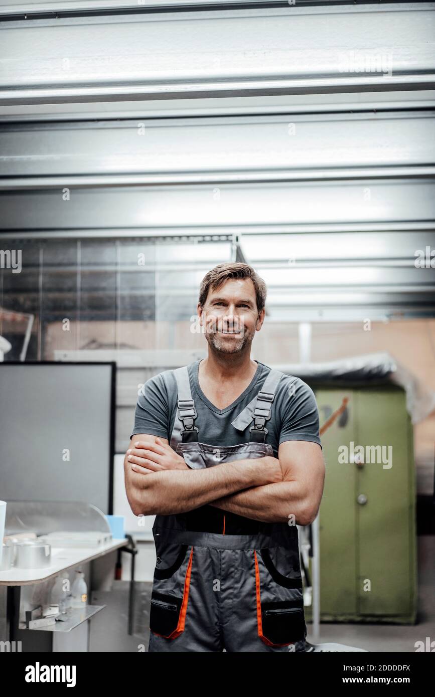 Confident male worker standing with arms crossed in industry Stock ...