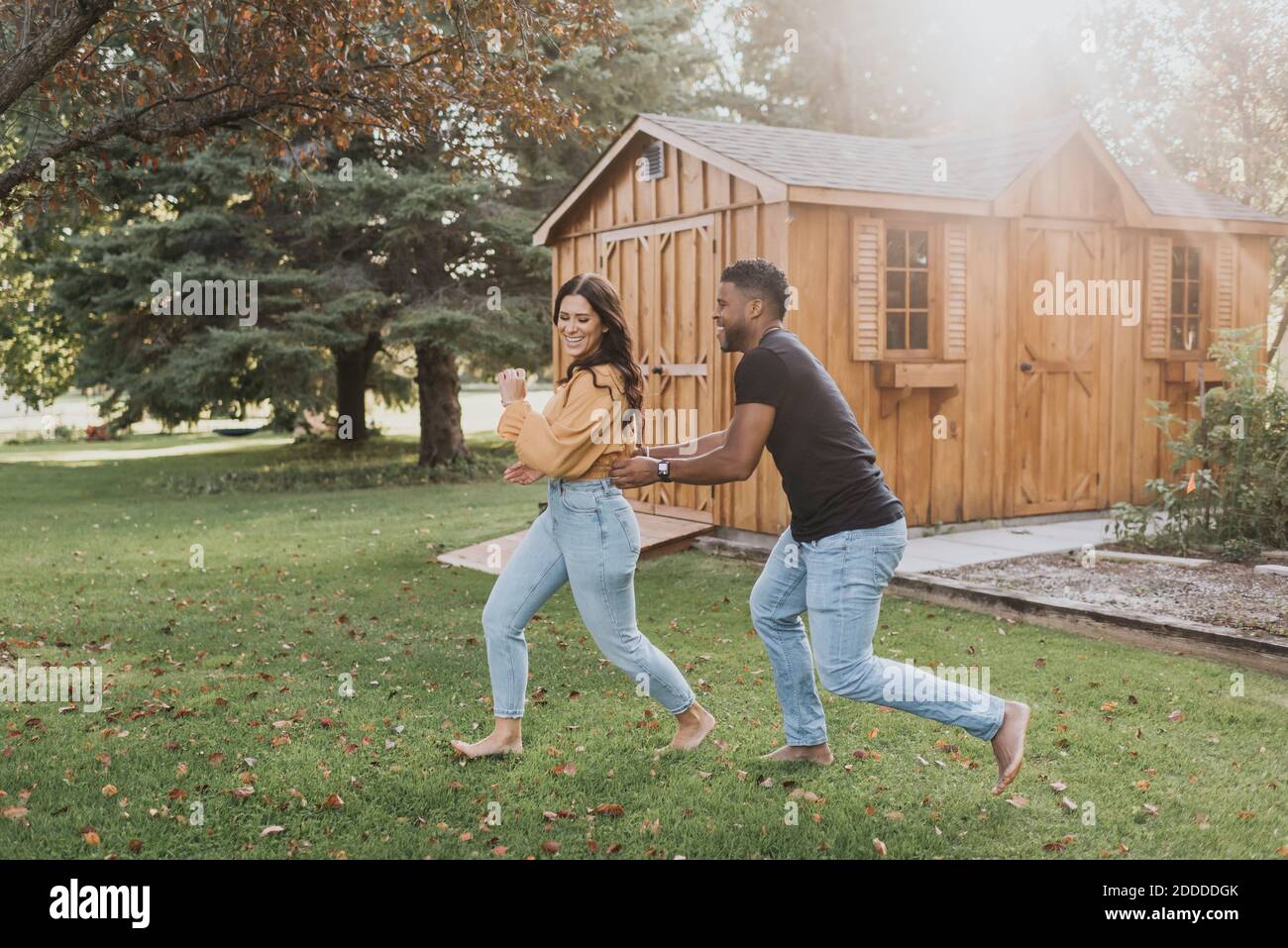 Boyfriend and girlfriend running while playing at backyard Stock Photo ...