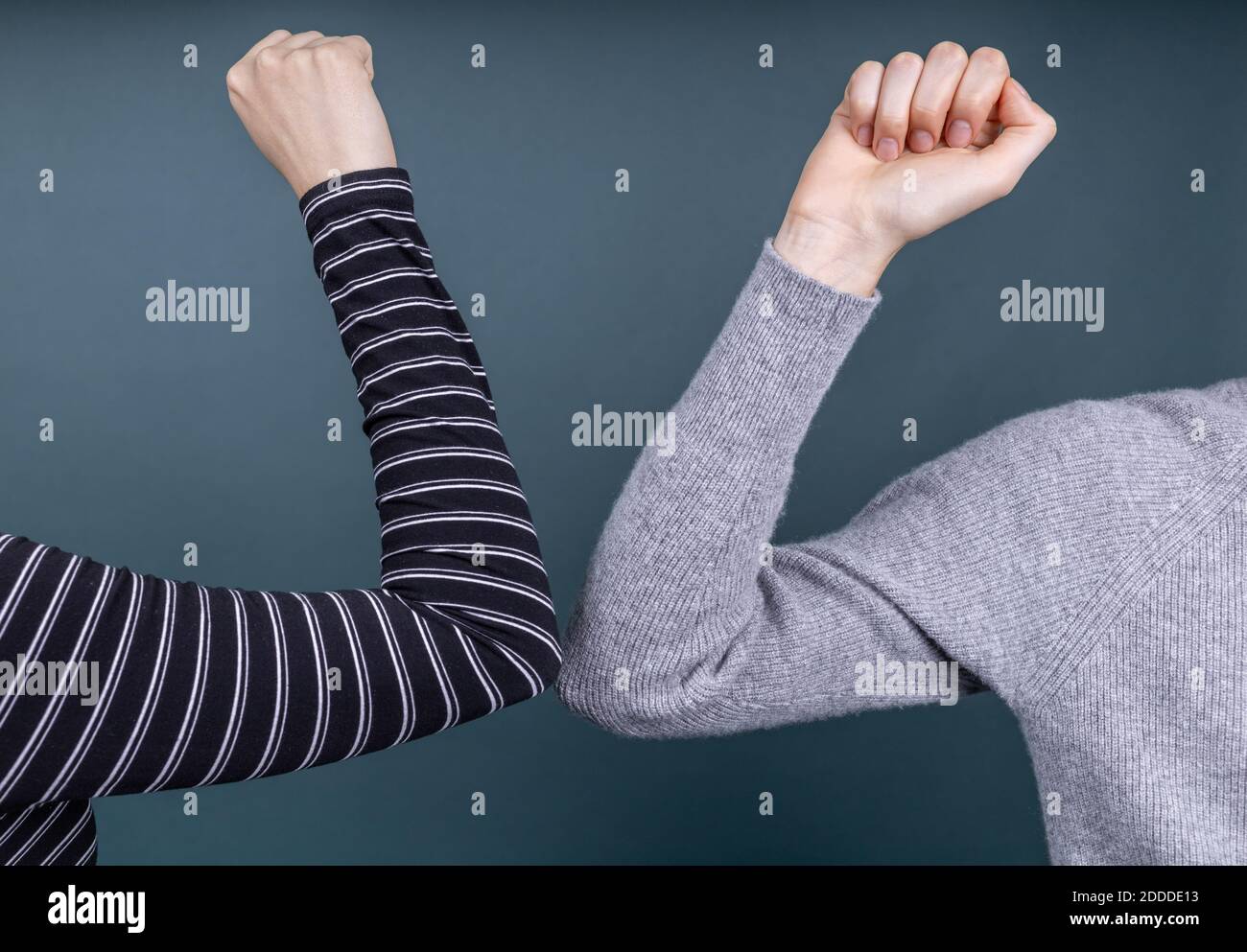 two people greeting each other with elbows Stock Photo - Alamy