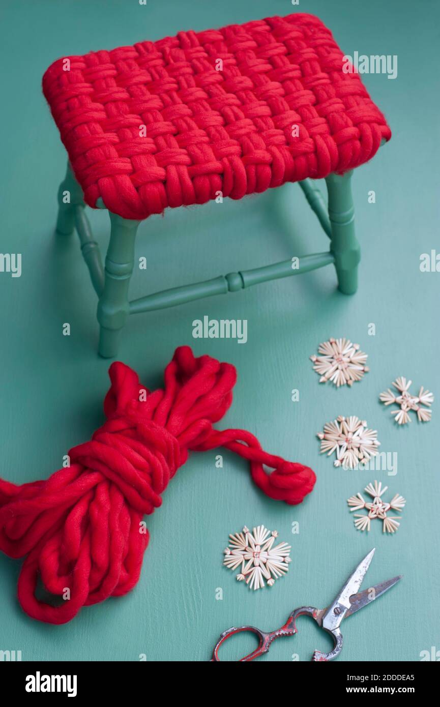 DIY straw snowflakes and wool cover for small simple stool Stock Photo ...