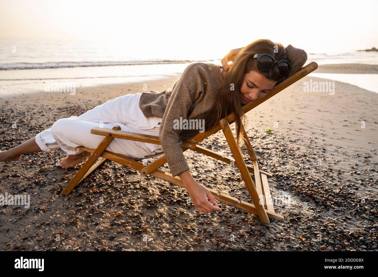 Woman reclining beach hi-res stock photography and images - Alamy