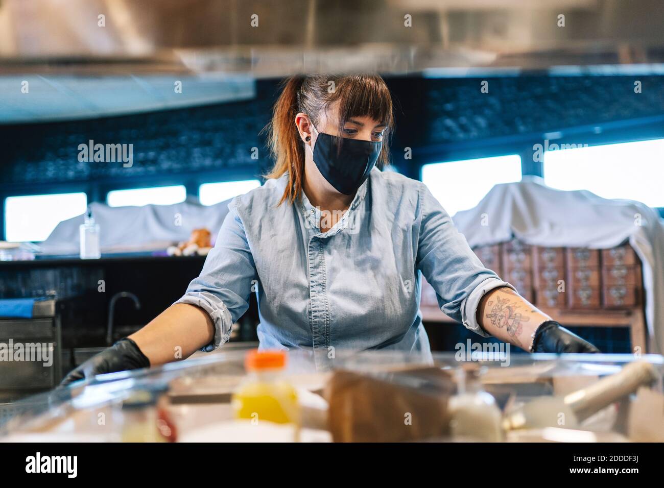 Female chef with take out food at restaurant during COVID-19 Stock ...