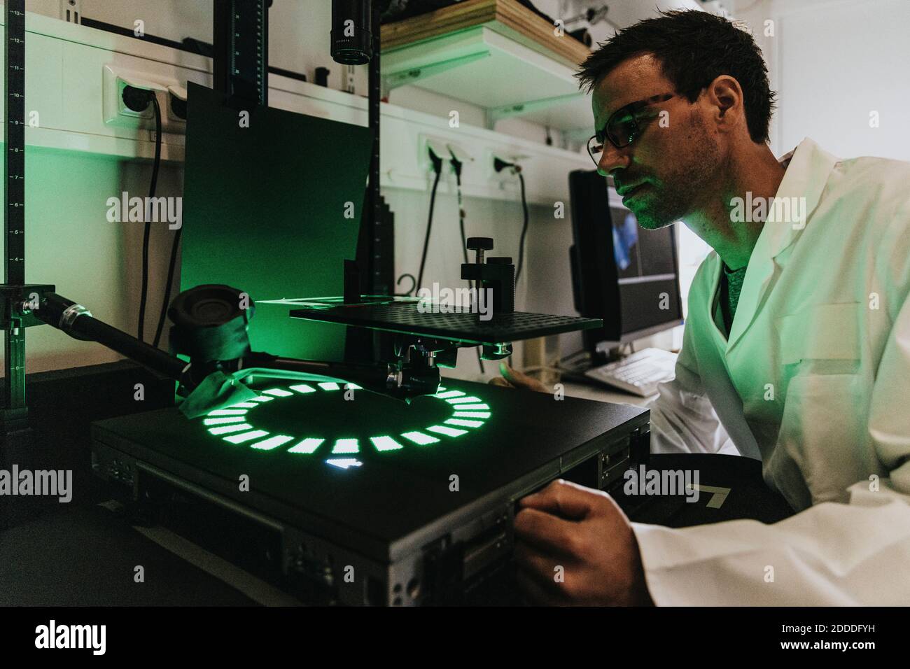 Scientist examining human brain slide on microscope while standing at ...