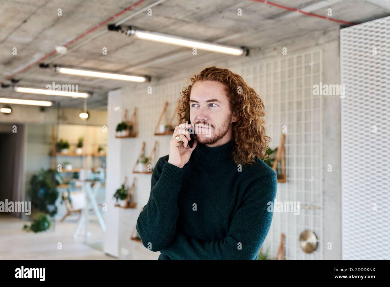Hipster looking at phone at home hi-res stock photography and images ...