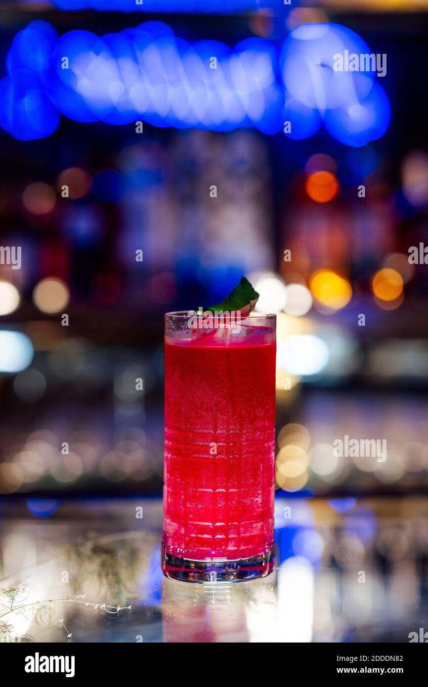 Glass of red colored cocktail Stock Photo - Alamy