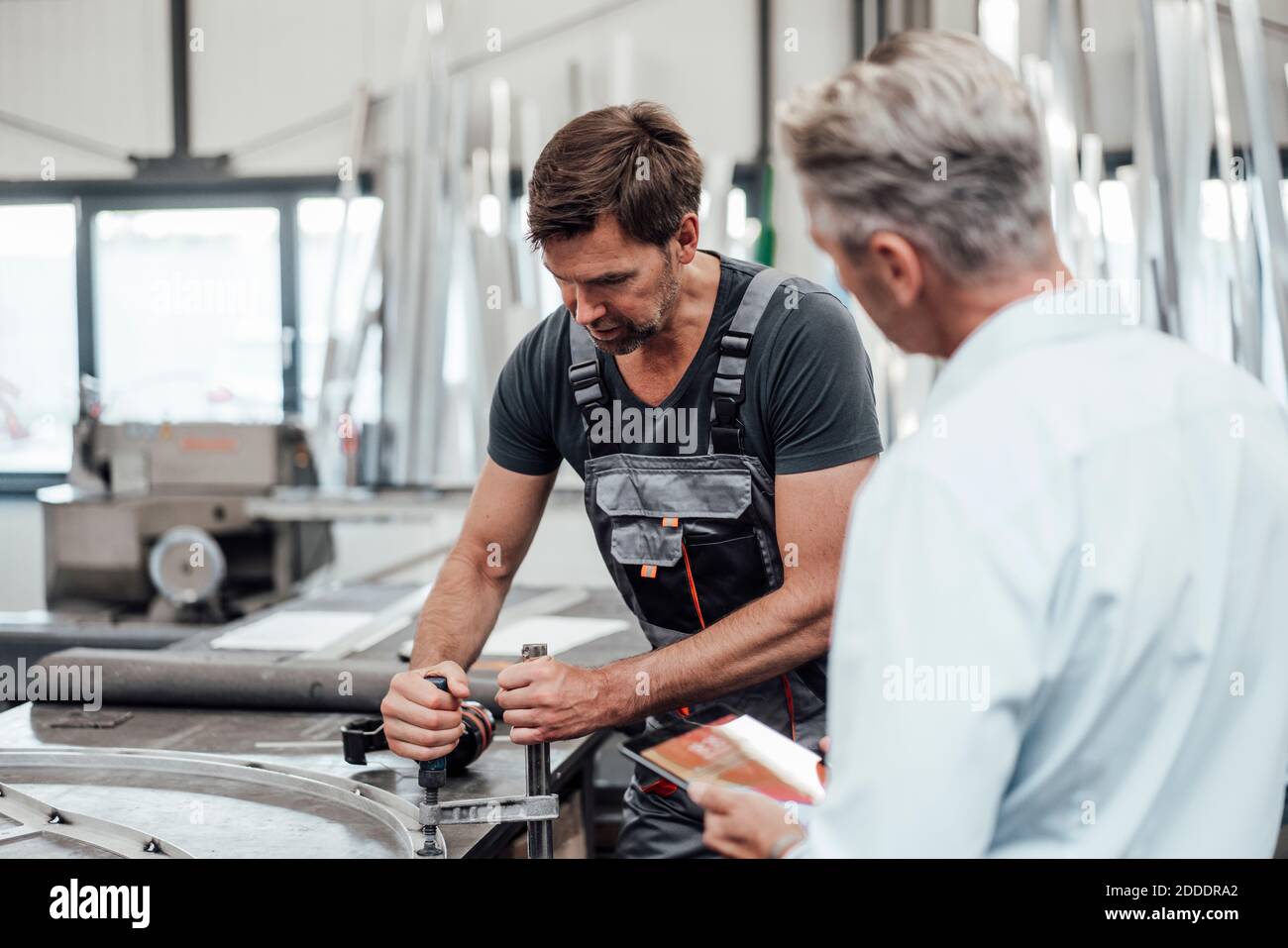 Worker operating machinery in manufacturing hi-res stock photography ...