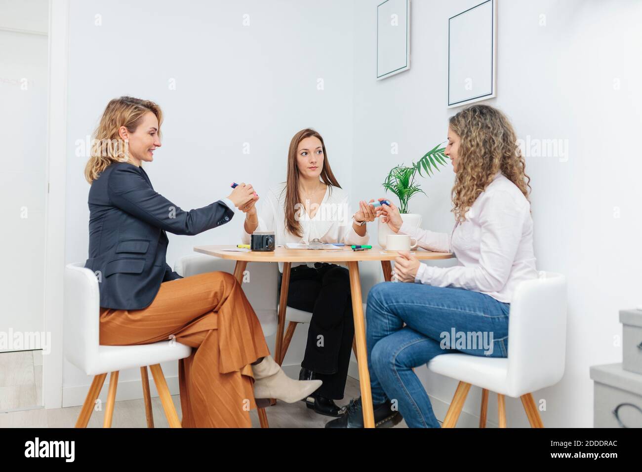 Woman handing over pen at office Stock Photo - Alamy