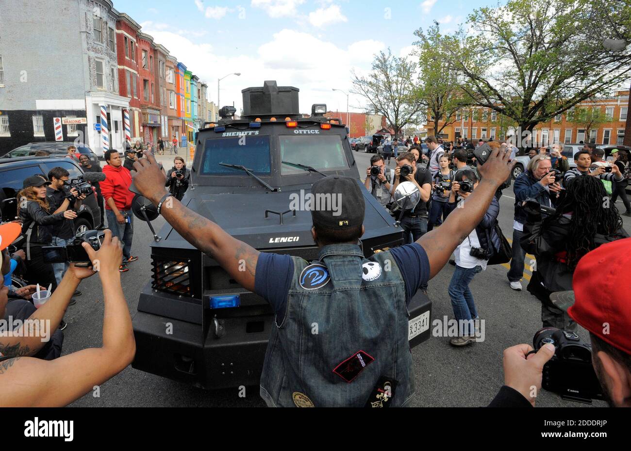 NO FILM, NO VIDEO, NO TV, NO DOCUMENTARY - Protesters follow a police ...