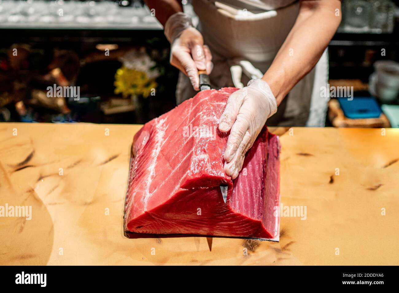 Male chef cutting fish at counter in kitchen of restaurant Stock Photo ...