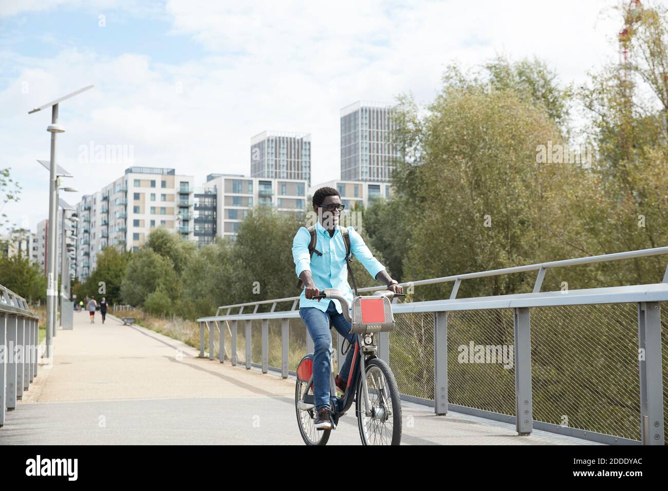 Smiling man commuting on bicycle in city Stock Photo - Alamy
