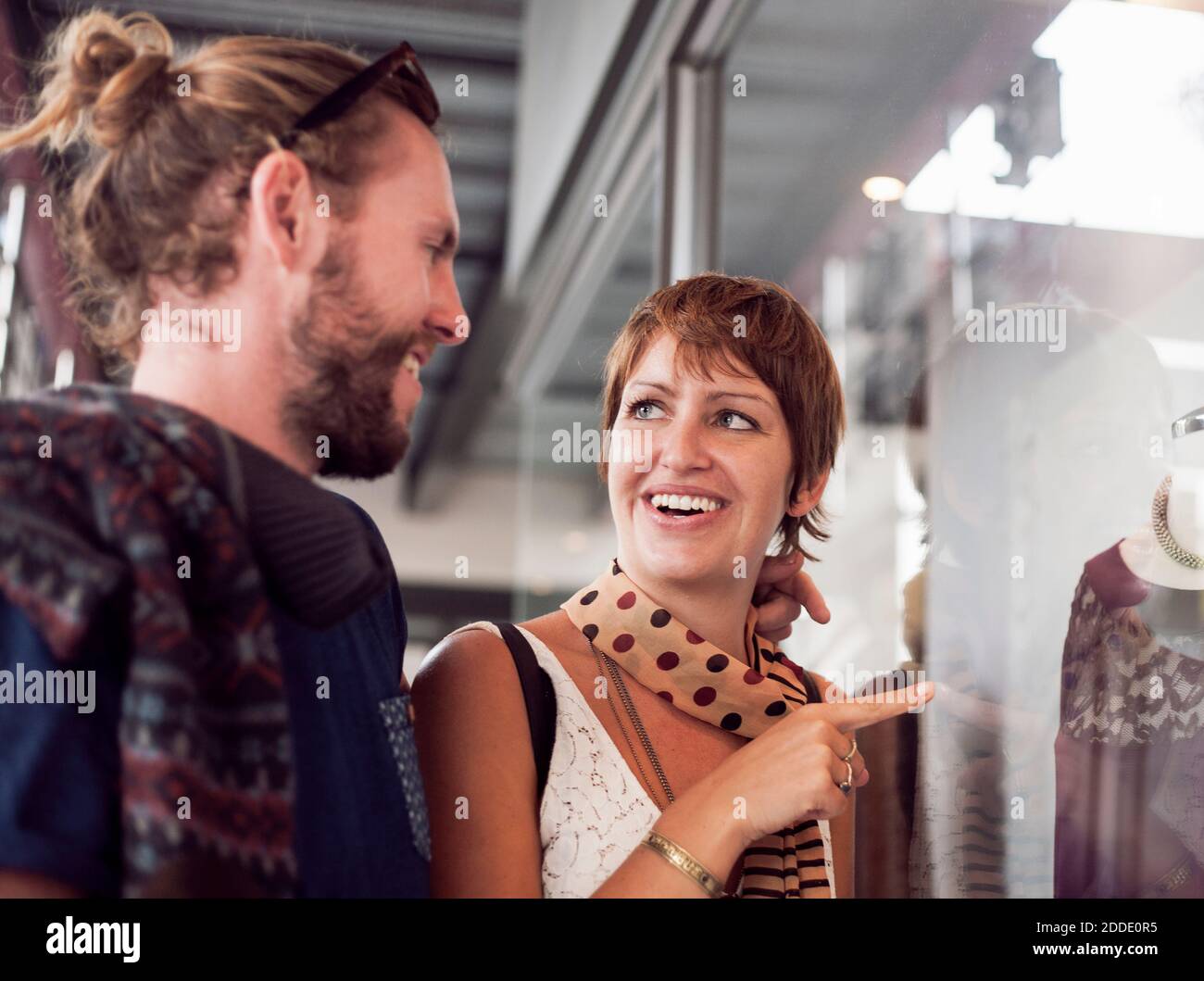 Couple doing window shopping in city Stock Photo - Alamy