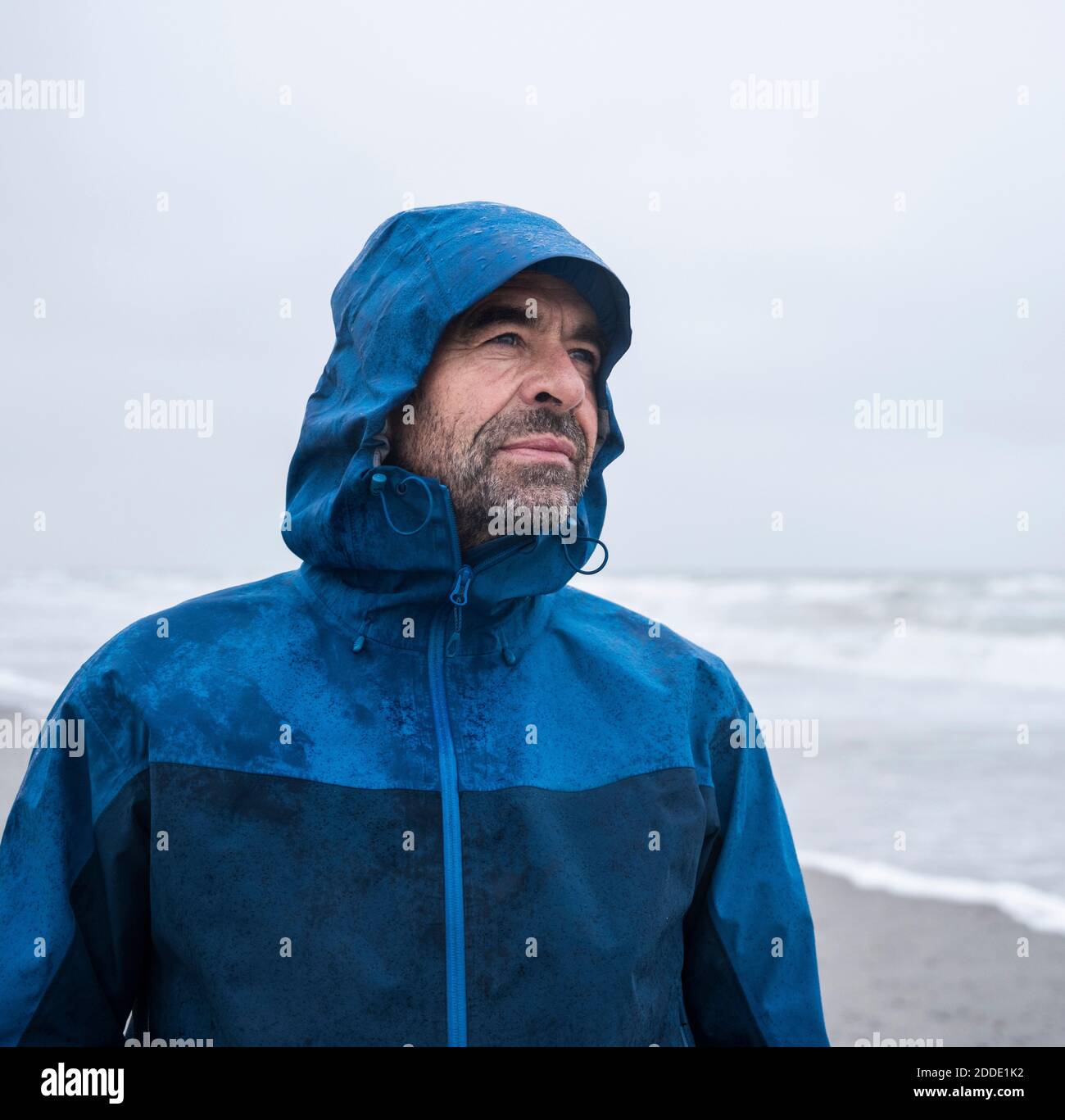 Blue raincoat hi-res stock photography and images - Alamy