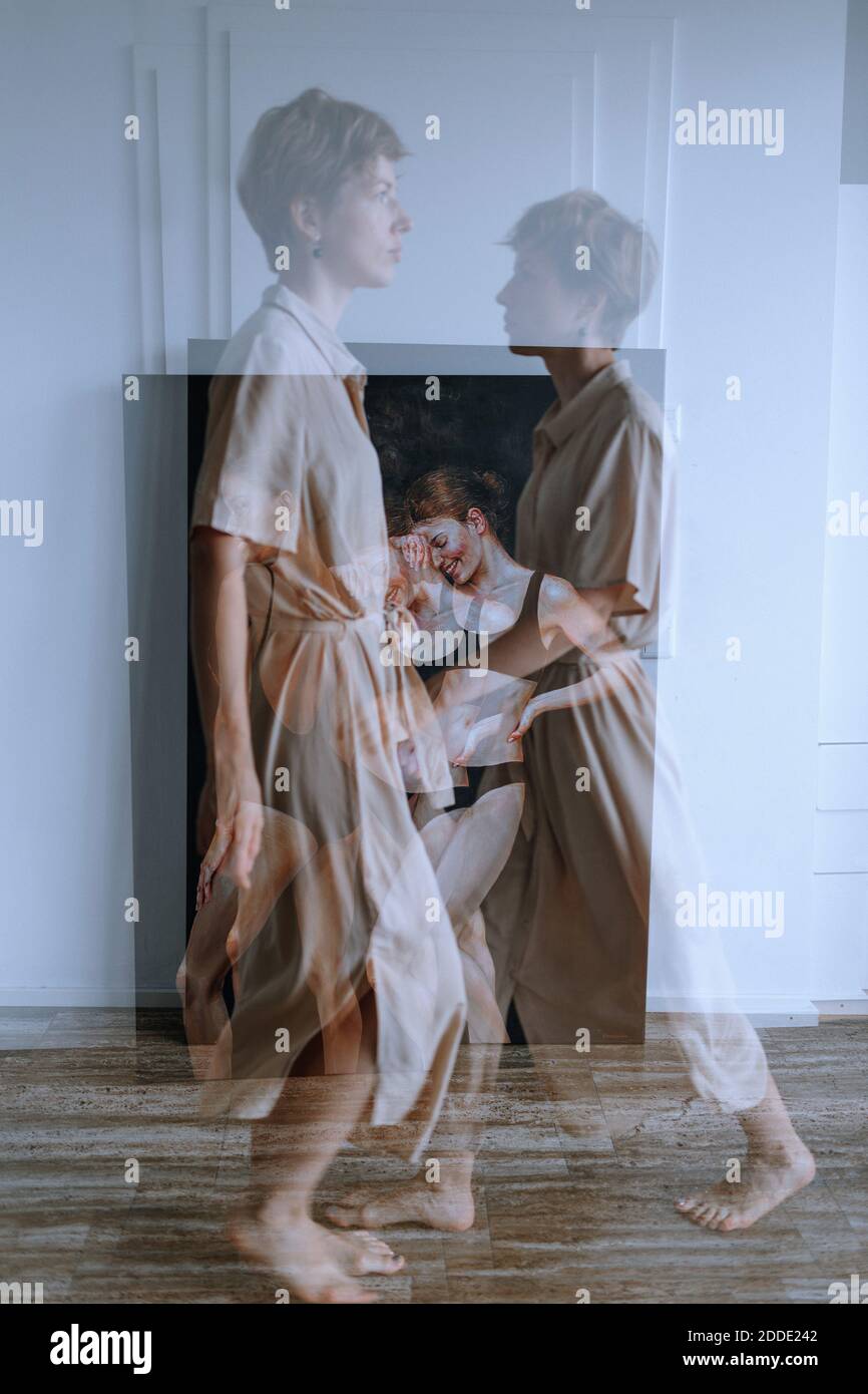 Multiple exposure of female artist walking in art studio Stock Photo ...