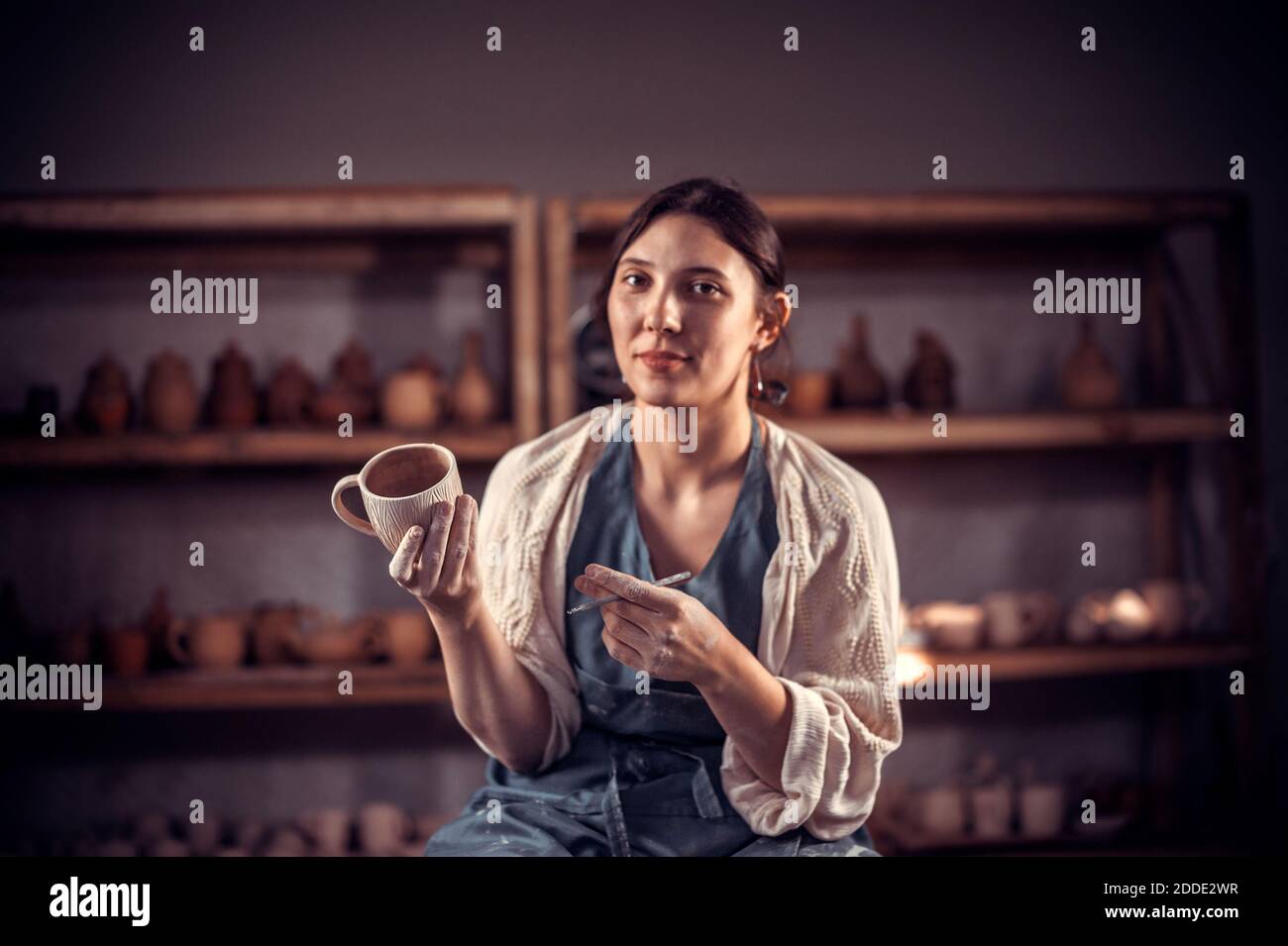 The potter works on a potter's wheel. Concept: handmade, workshop ...