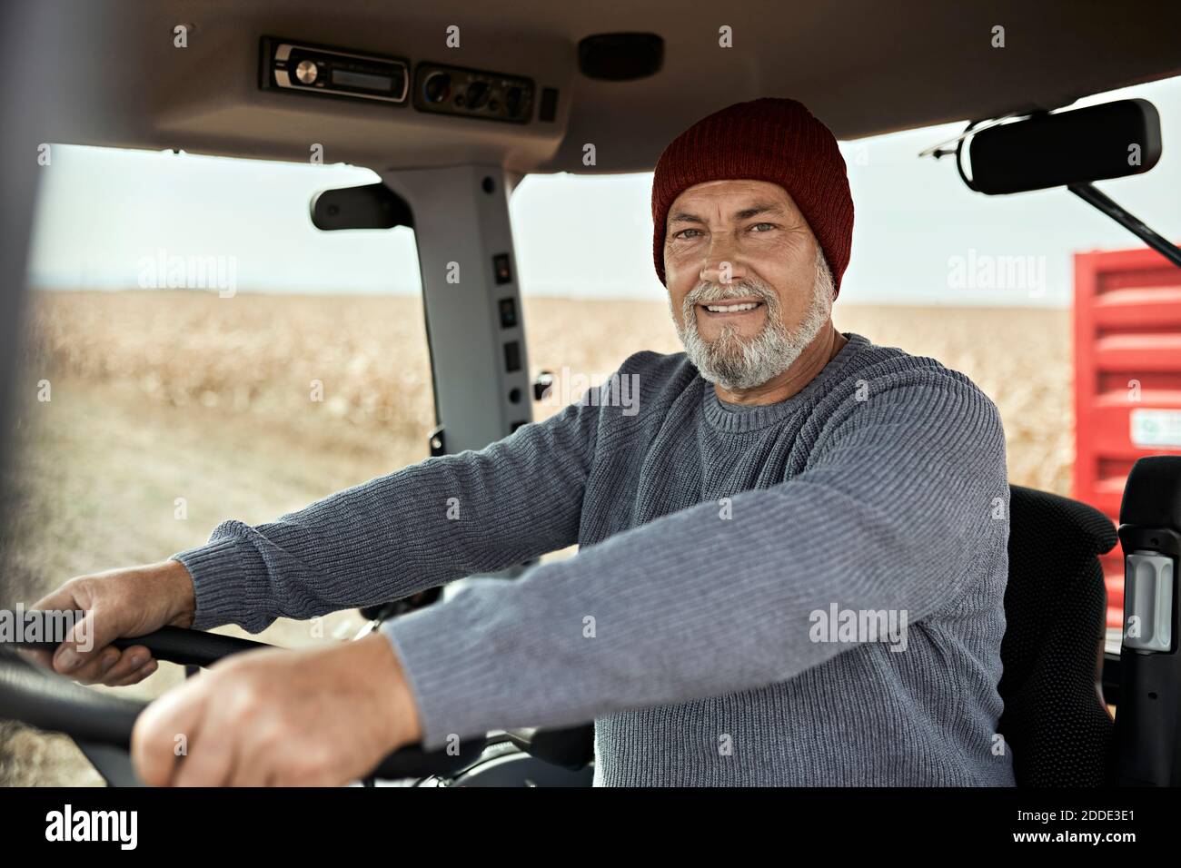 Farmer driving tractor while working at soybean farm Stock Photo - Alamy