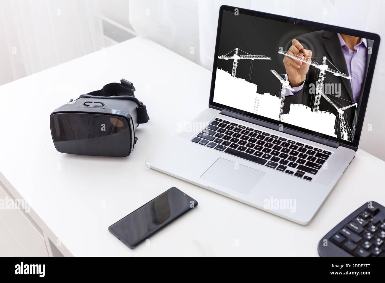 young manual worker displaying laptop over white background Stock Photo ...