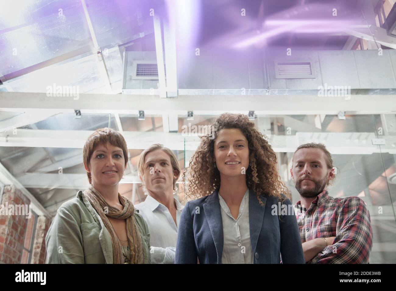 Confident team standing together at office Stock Photo - Alamy