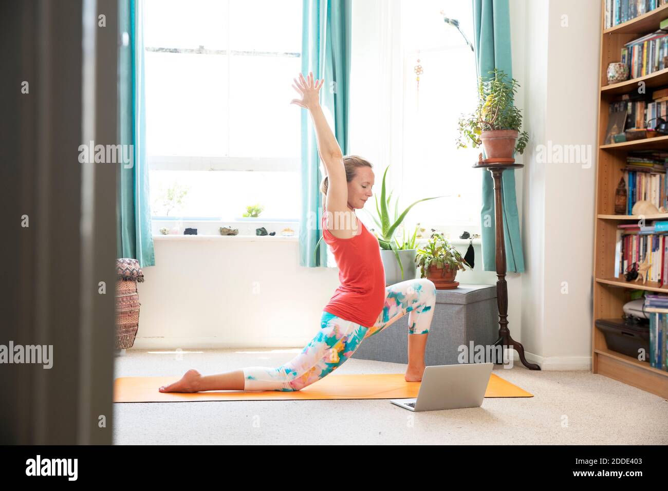Sportswoman doing hand raised exercise at home Stock Photo - Alamy
