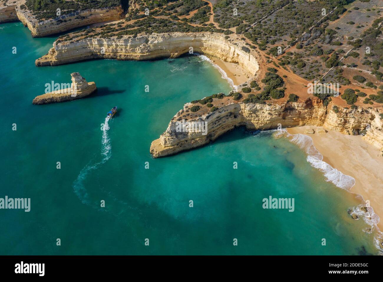 Drone view of tourboat sailing by Praia do Pontal and Praia da Morena ...
