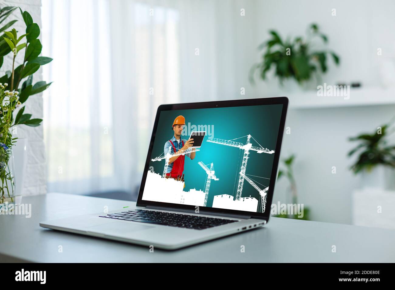 young manual worker displaying laptop over white background Stock Photo ...