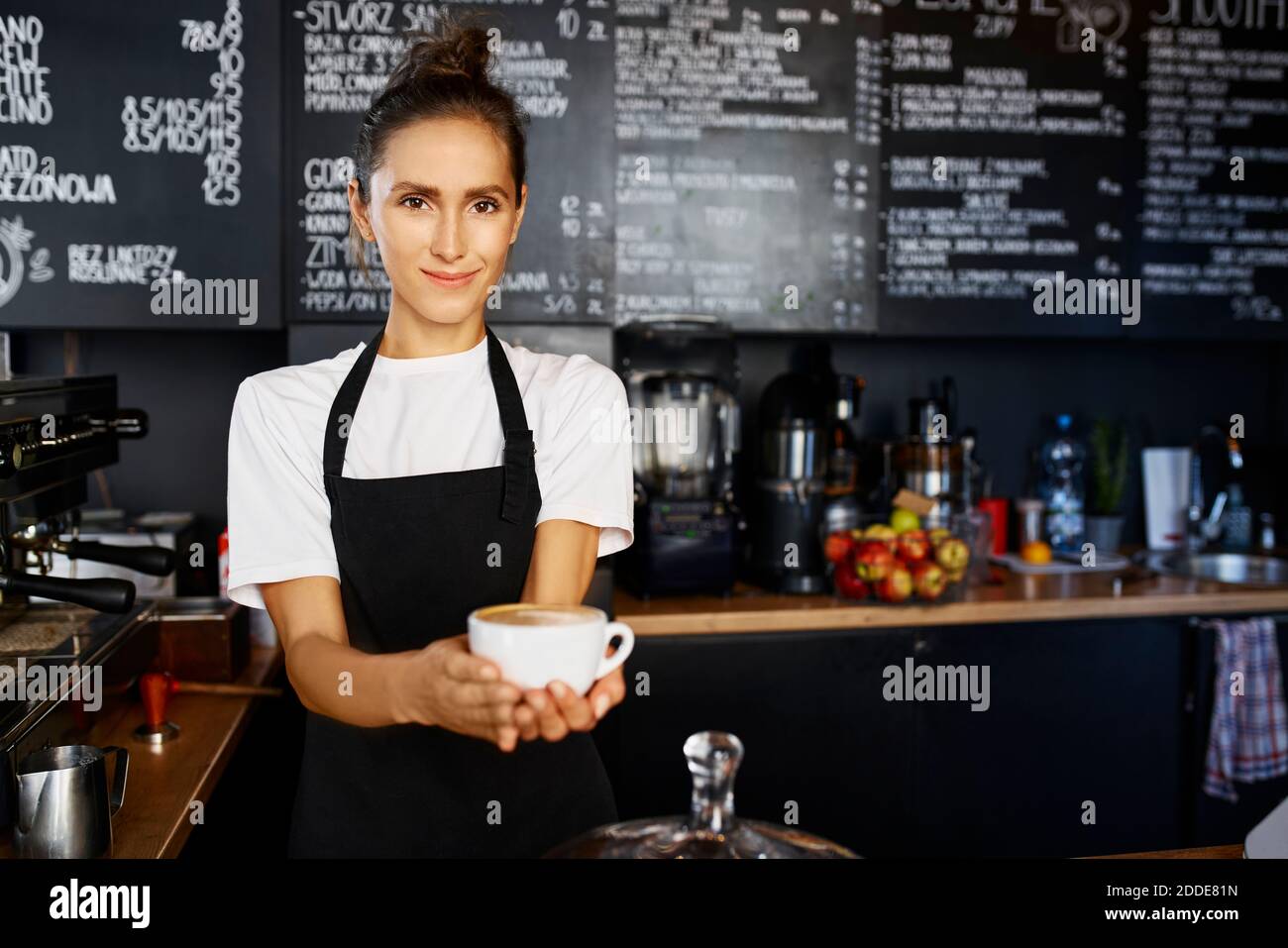 Portrait of smiling waitress giving coffee at cafe Stock Photo - Alamy