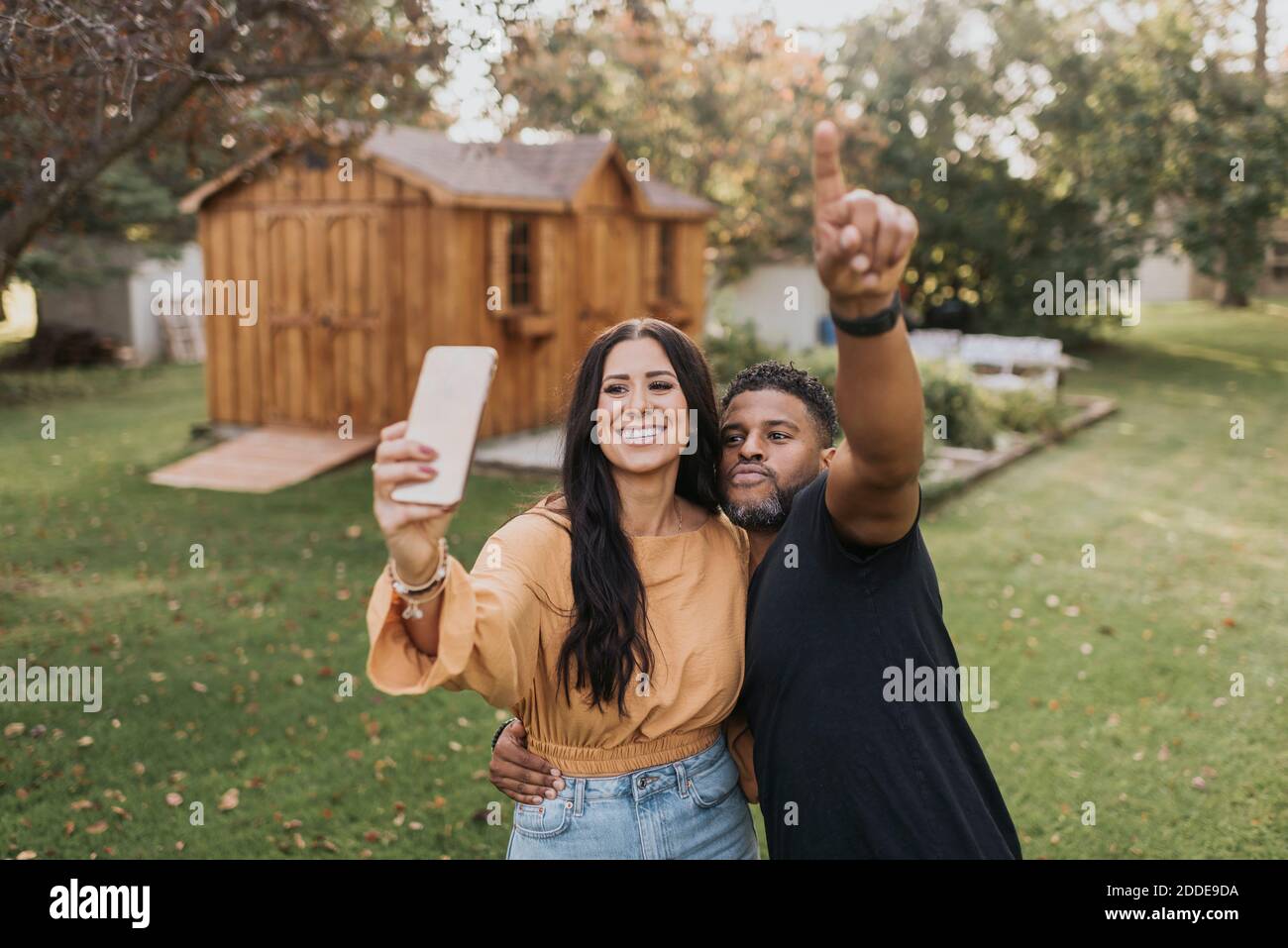 Mid Adult Woman Taking Selfie With Man Through Mobile Phone While