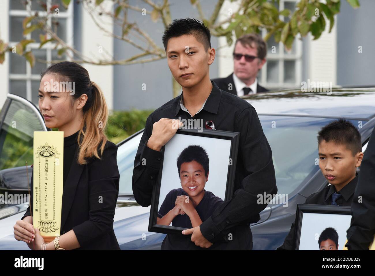 NO FILM, NO VIDEO, NO TV, NO DOCUMENTARY - Jason Wang, center, holds a ...