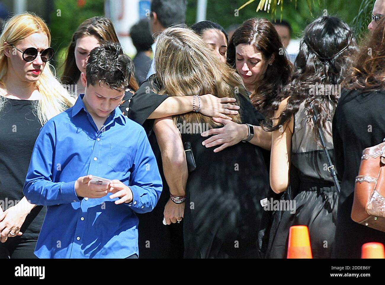 NO FILM, NO VIDEO, NO TV, NO DOCUMENTARY - Mourners hug and console ...