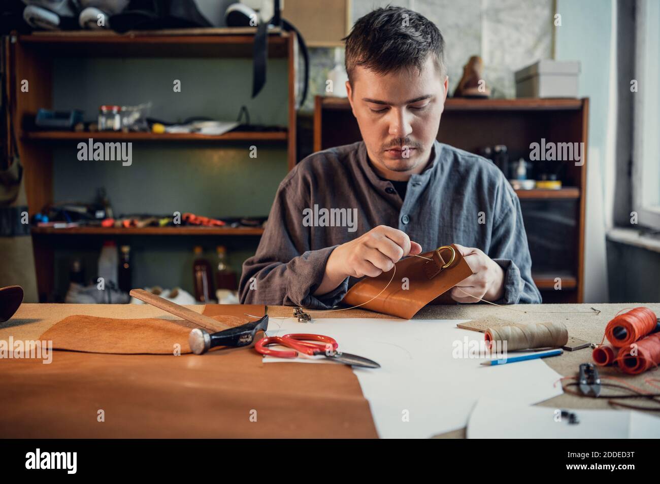 Portrait of a professional shoemaker in the interior of a shoemaker's ...