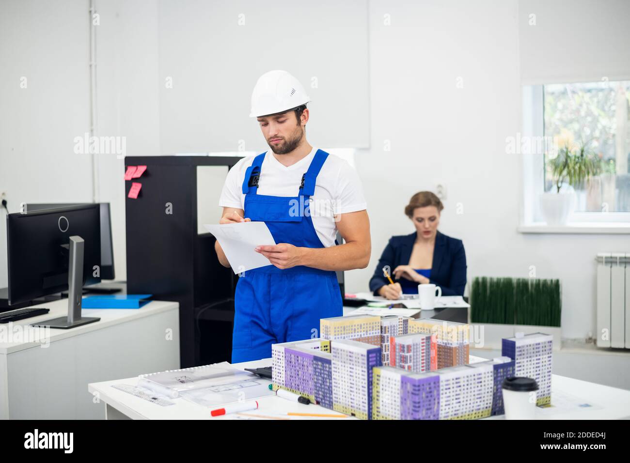 Confident architect with jacket and hard hat Stock Photo - Alamy