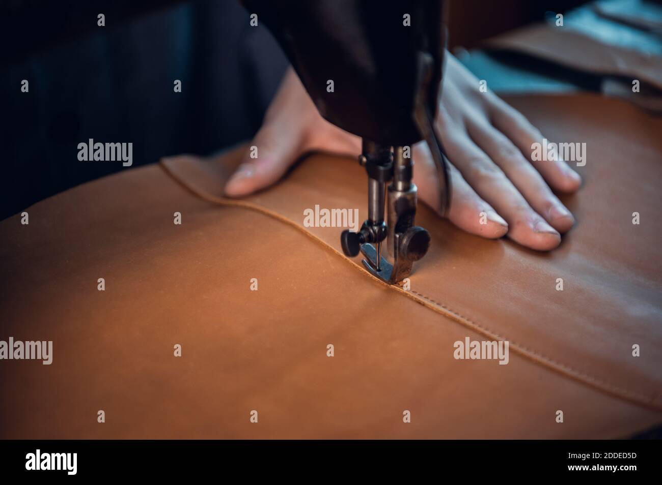 Close-up of the sewing machine needle guide makes an even seam with a ...