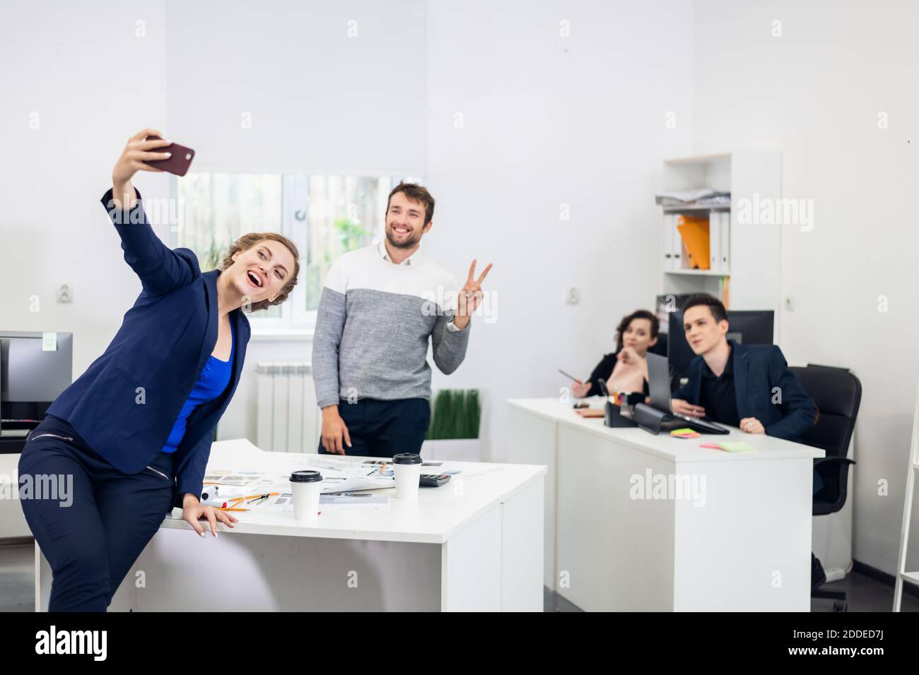 Selfie time. Office workers taking selfies at work Stock Photo - Alamy