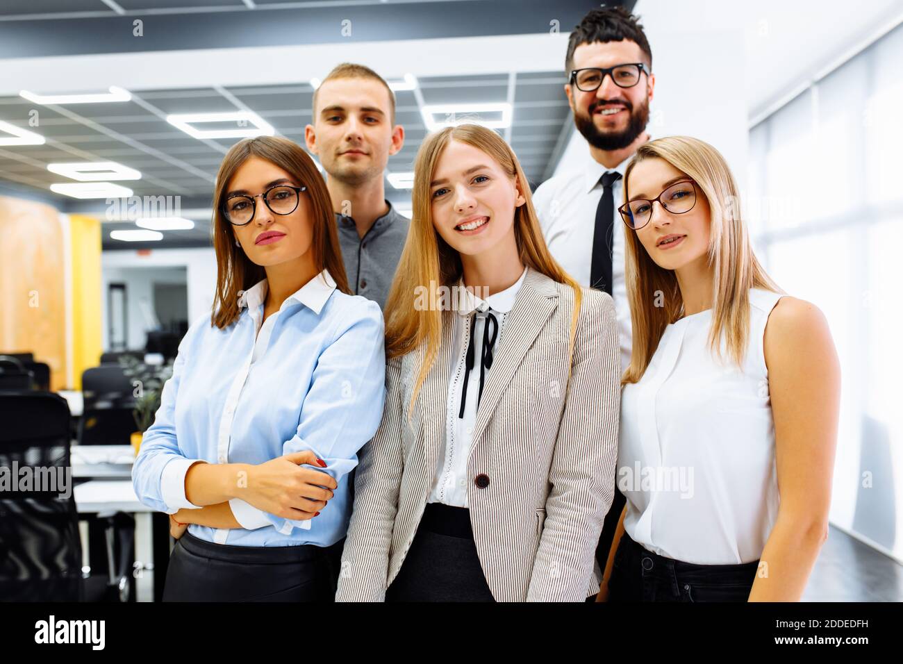 Successful business team standing together and smiling working in the ...