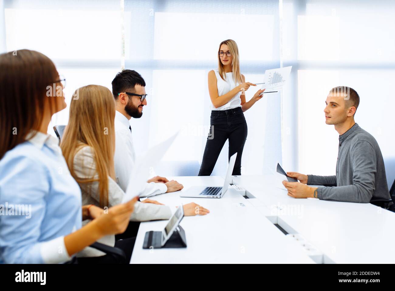 Successful team leader leading business meeting with colleagues ...