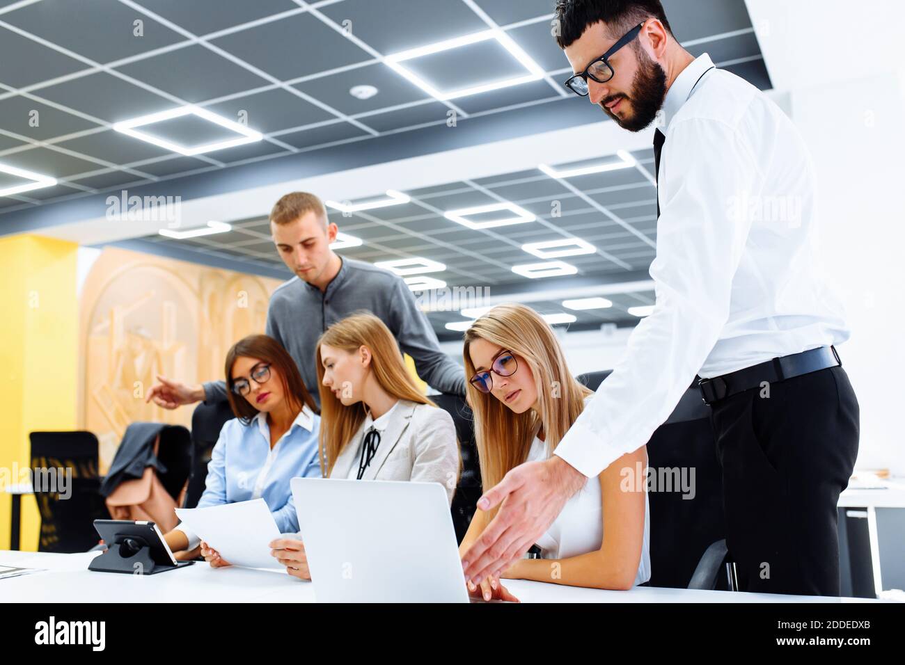 Business team working on a new project and smiling while sitting at ...
