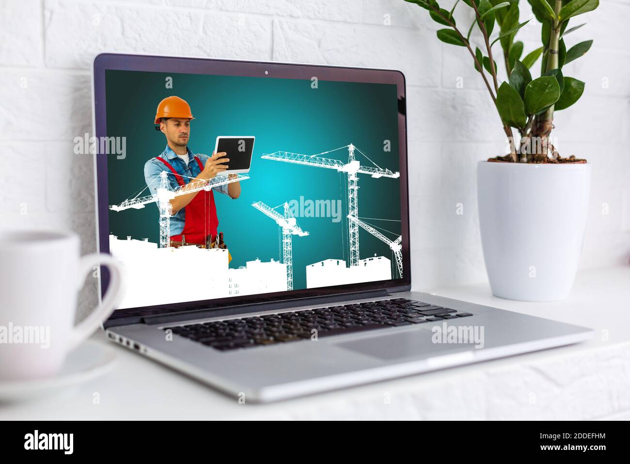 young manual worker displaying laptop over white background Stock Photo ...