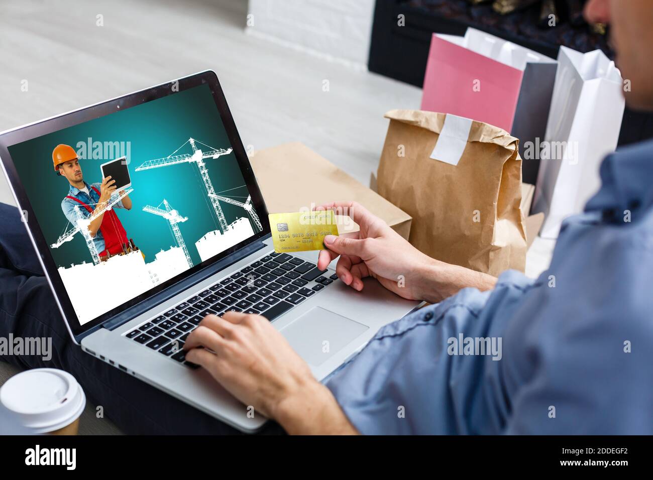 young manual worker displaying laptop over white background Stock Photo ...