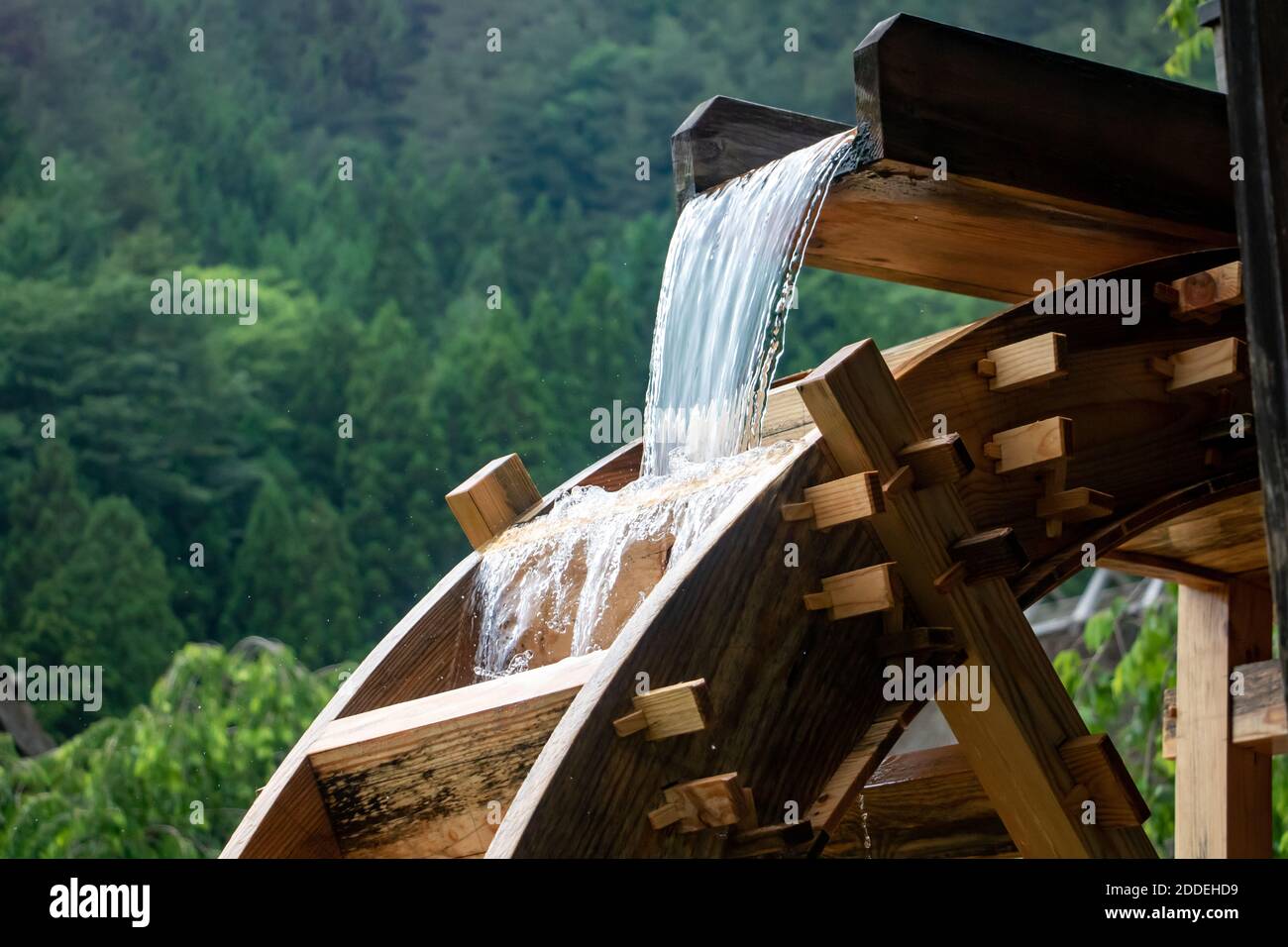 The mill wheel rotates under a stream of water, close up Stock Photo ...