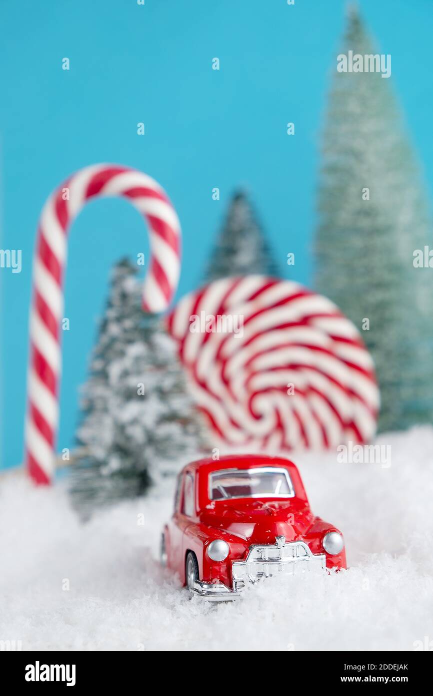 Red Santa car with in Christmas tree forest with candies and lollipops ...