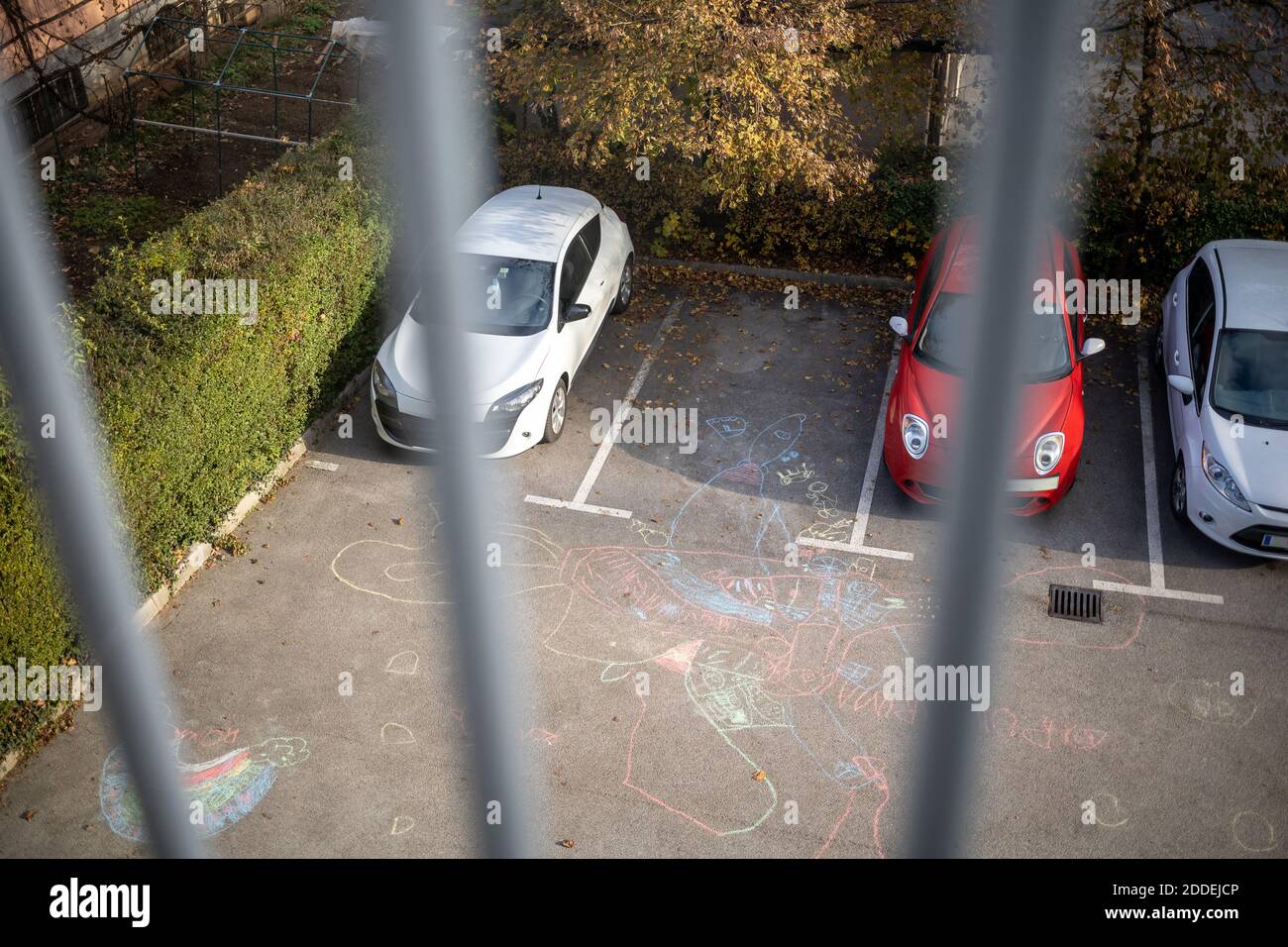 view to yard and parking through window with bars Stock Photo - Alamy
