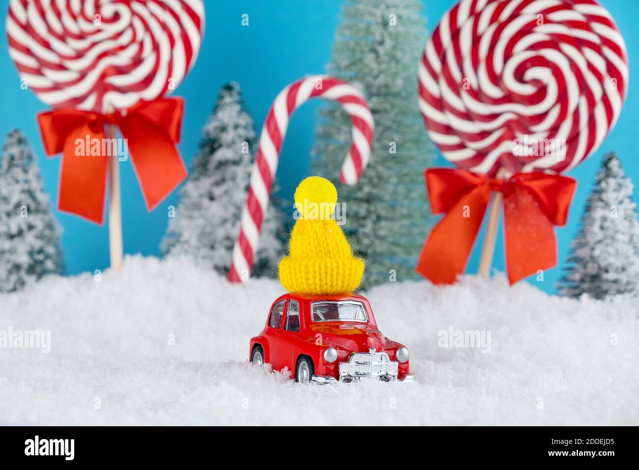 Red Santa car with in yellow winter cap and Christmas tree forest with ...