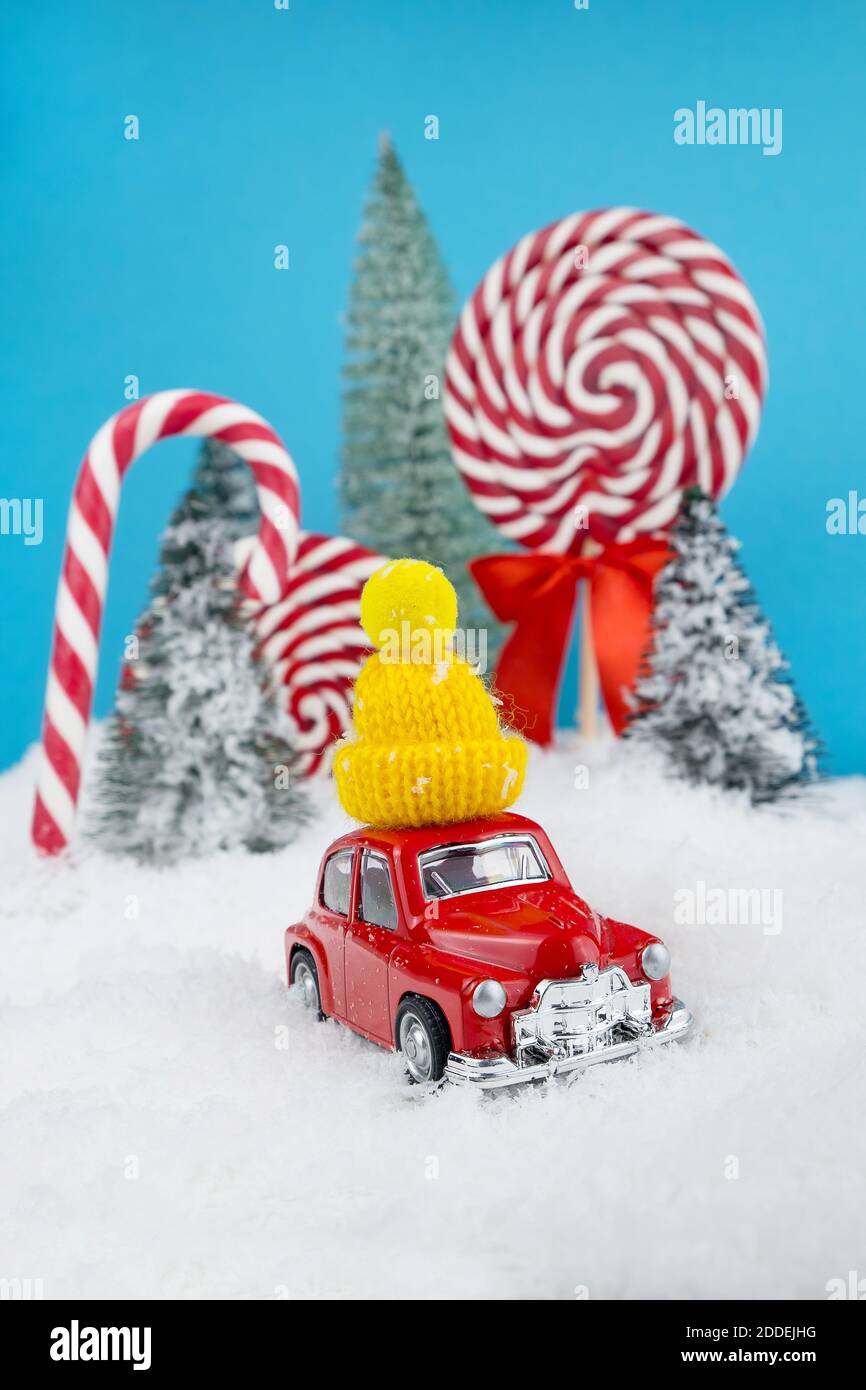 Red Santa car with in yellow winter cap and Christmas tree forest with ...