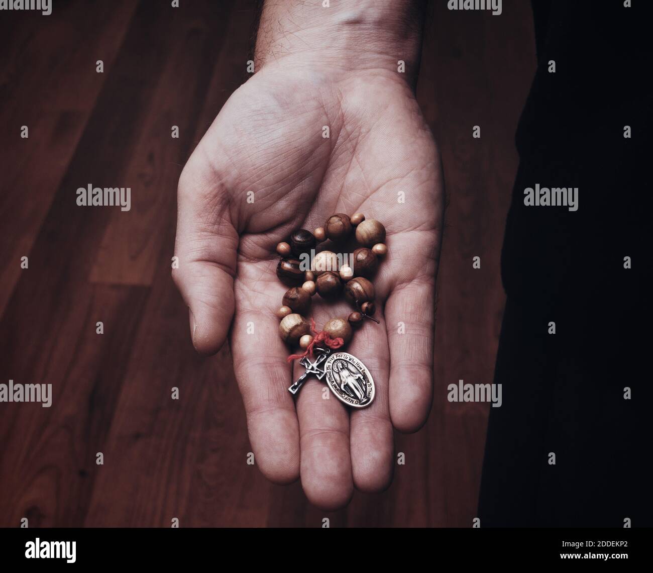 Rosary bracelet in open hand Stock Photo - Alamy