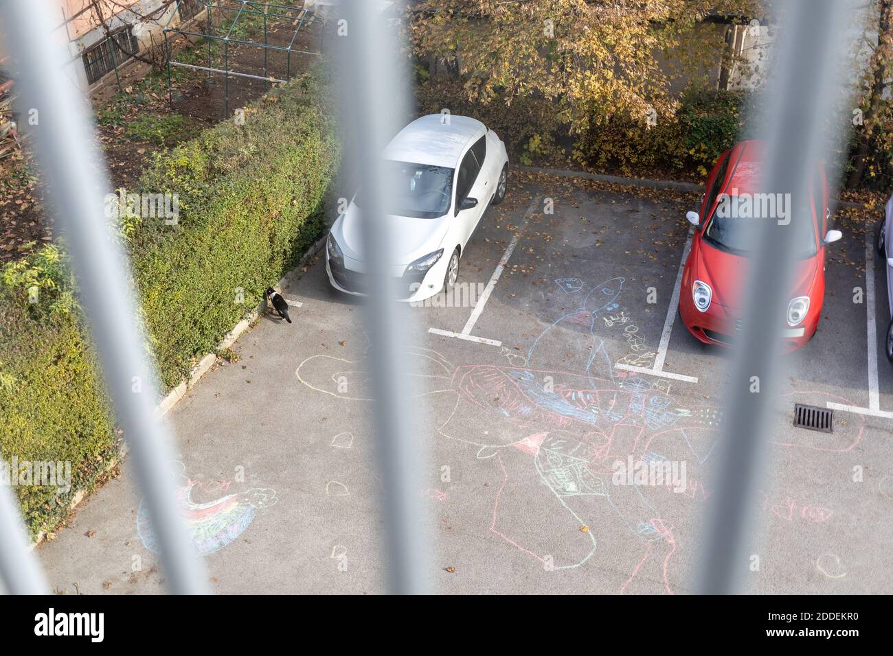 view to yard and parking through window with bars Stock Photo - Alamy
