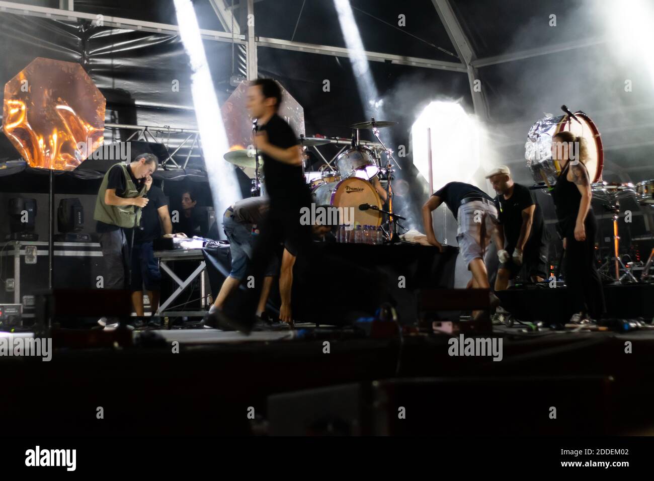 Roadies or riggers working on stage for music industry. Music stage ...