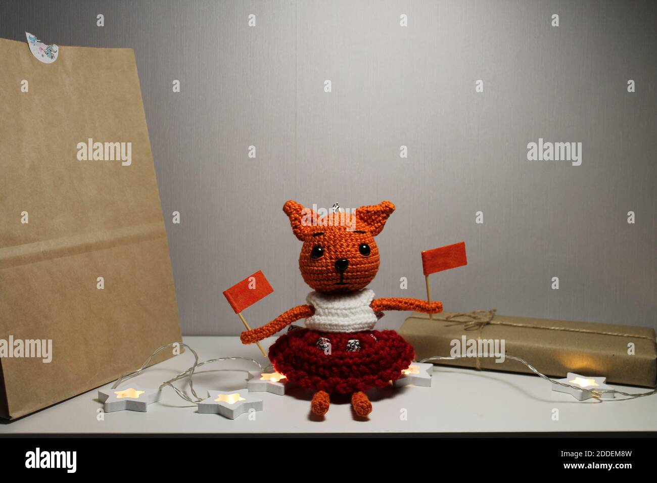 Knitted squirrel for kids holds flags for inscription Stock Photo - Alamy