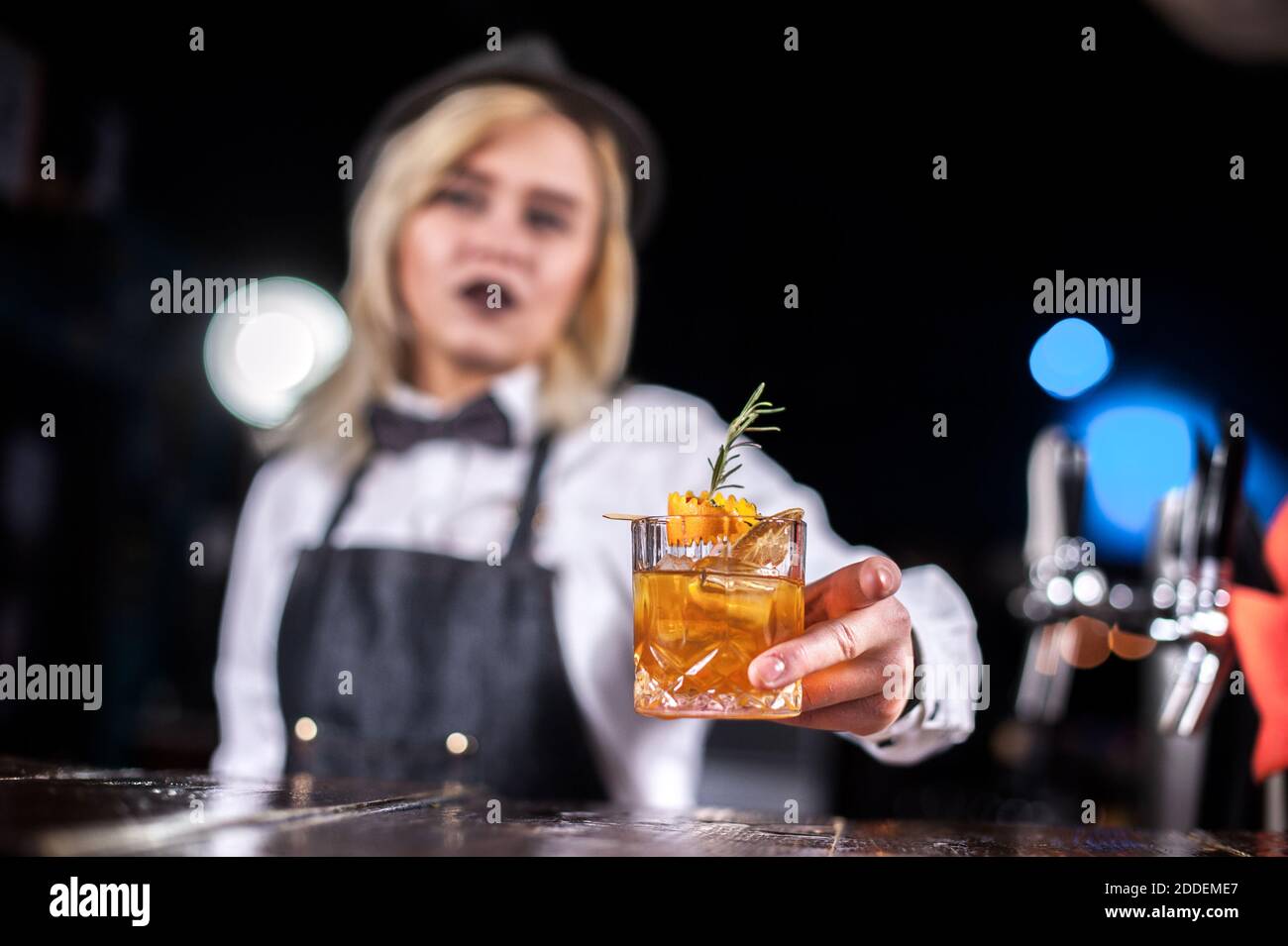 Girl bartender creates a cocktail on the saloon Stock Photo - Alamy