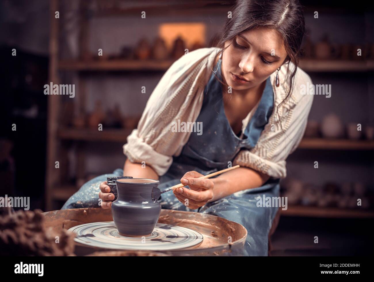 Stylish craftsman at his wheel creating a new masterpiece. Handicraft ...