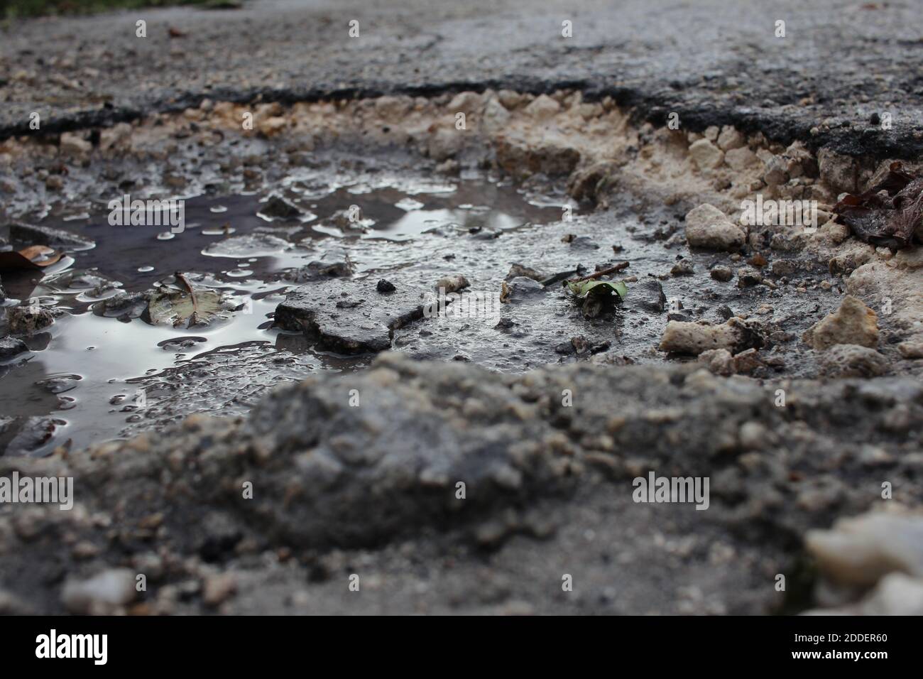 Pothole and puddle in road hi-res stock photography and images - Alamy