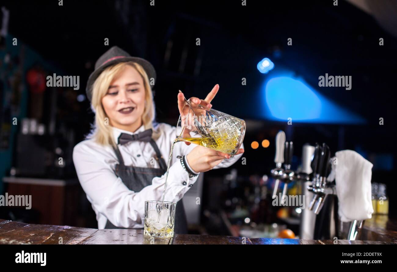Girl barman makes a cocktail on the saloon Stock Photo - Alamy